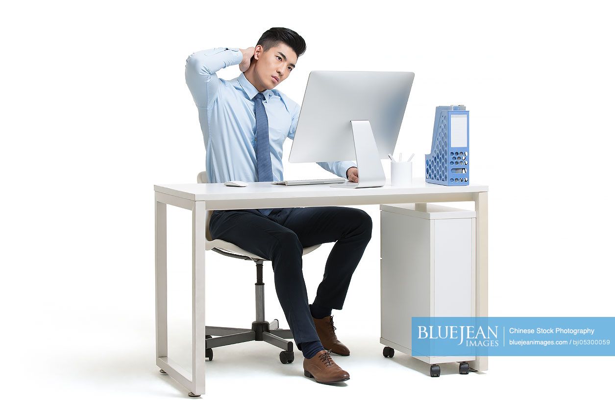 Tired young Chinese businessman working in office-High-res stock photo ...