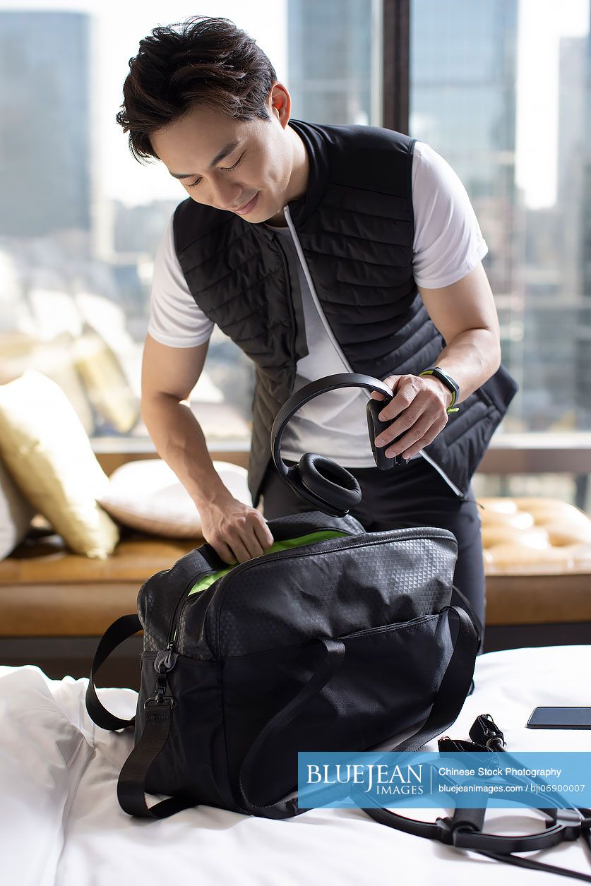 Chinese mid adult man getting ready to go out and workout-High-res ...