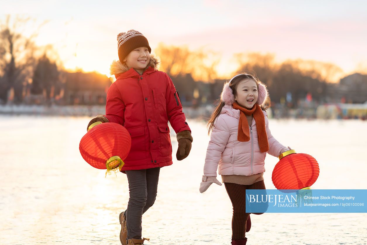 Happy Chinese sibling running on ice-High-res stock photo for download