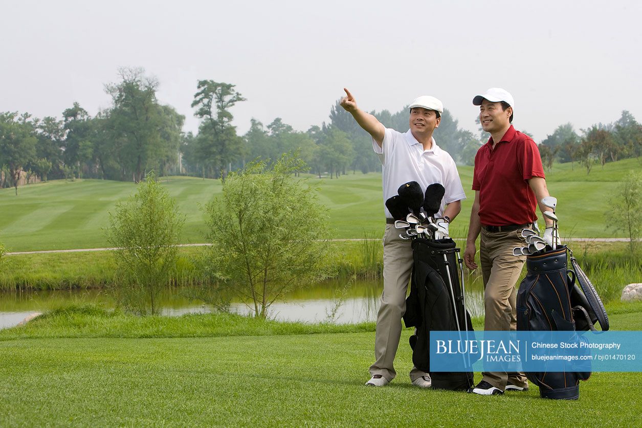 Two Chinese golfers pointing forward-High-res stock photo for download