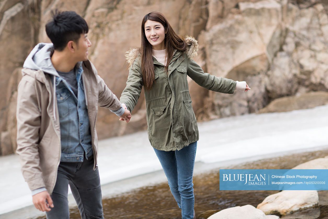 Happy young Chinese couple enjoying winter outing-High-res stock photo for download