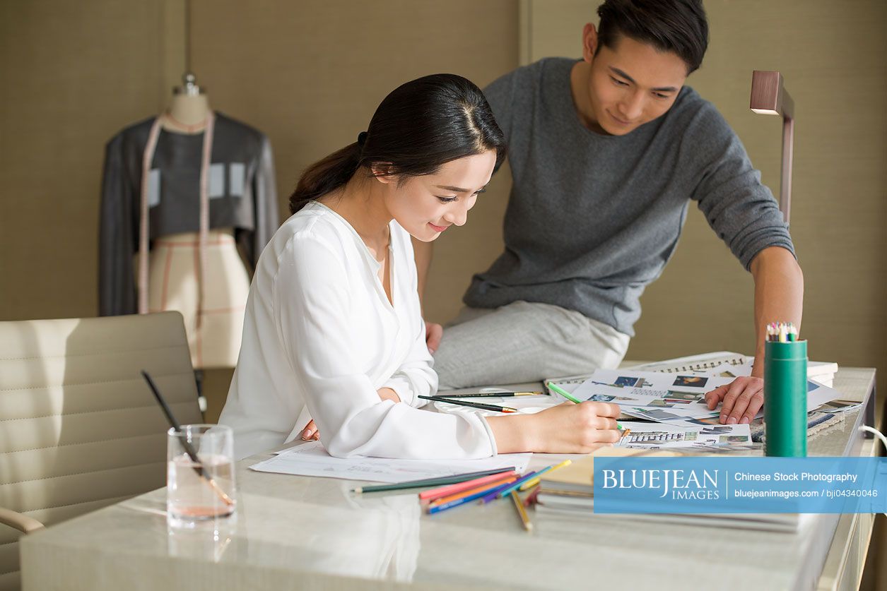 Two Chinese fashion designers drawing sketch-High-res stock photo for download