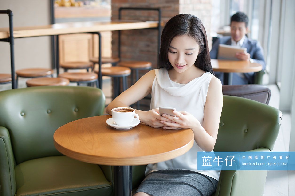 年轻女子在咖啡厅使用手机-蓝牛仔影像-中国原创广告影像素材