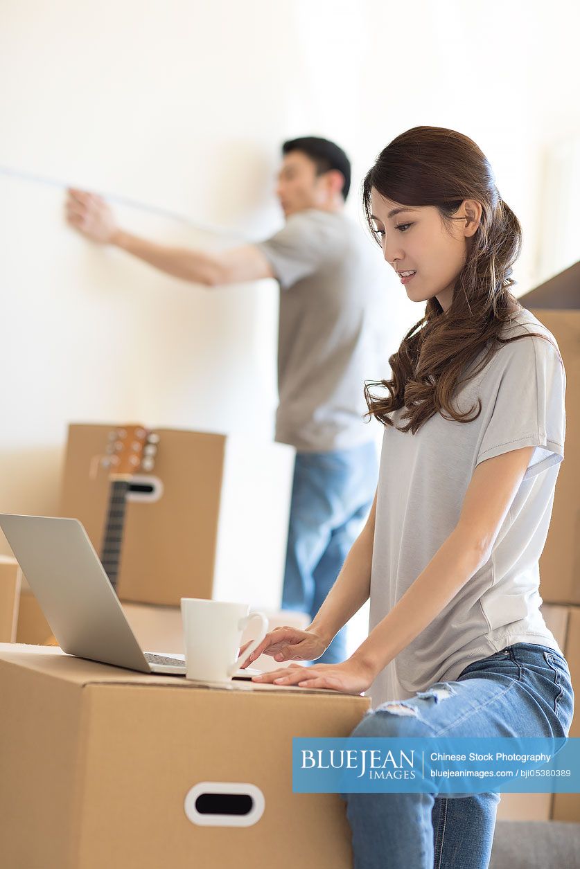 Happy young Chinese couple moving to a new house-High-res stock photo ...
