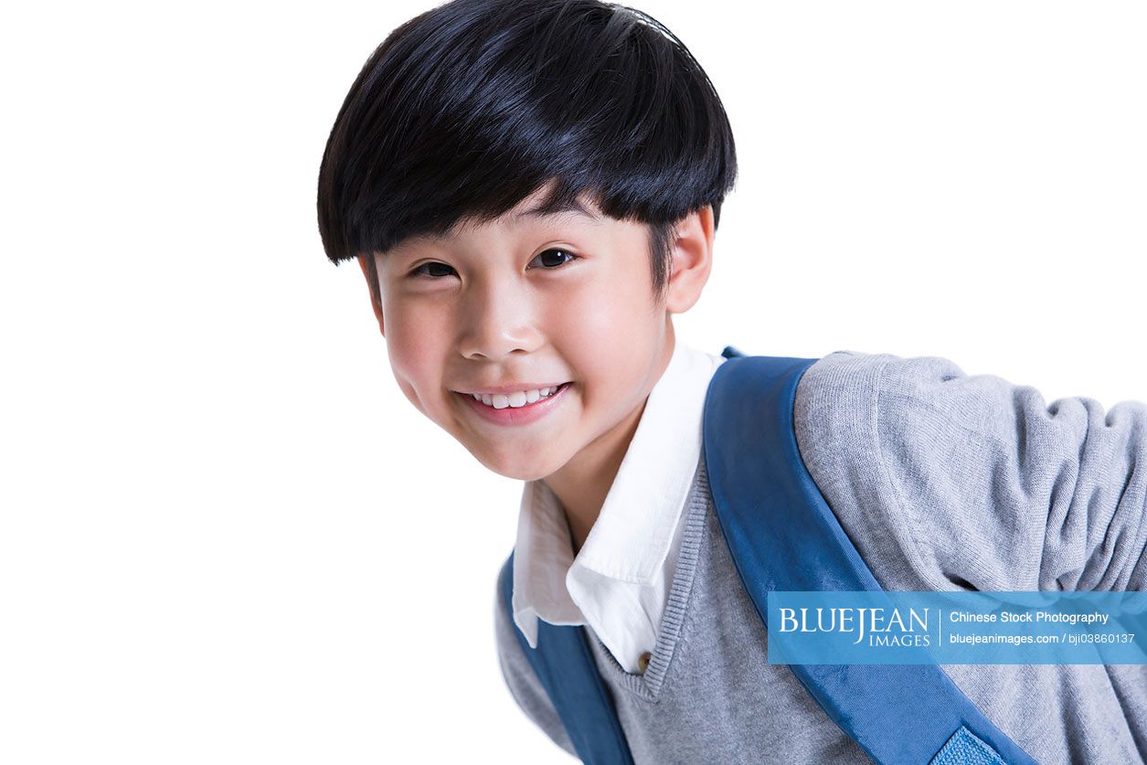 Happy Chinese boy with schoolbag on back-High-res stock photo for download