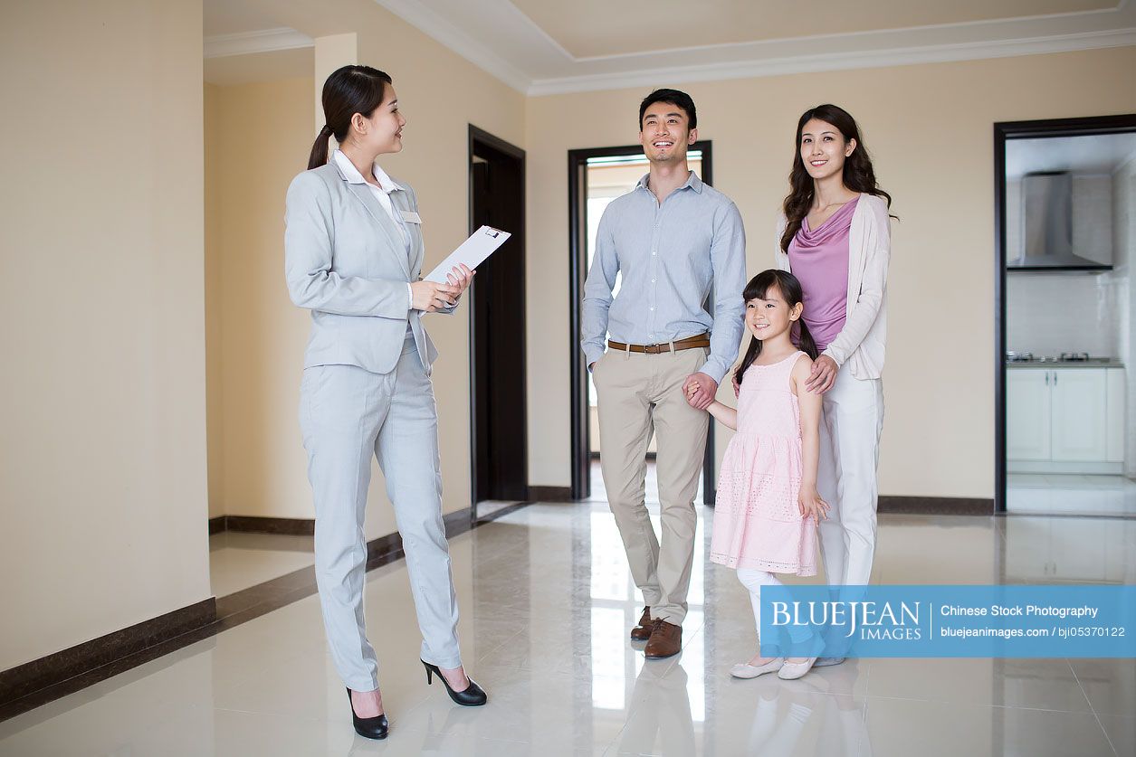 Chinese realtor showing new house to young family-High-res stock photo ...
