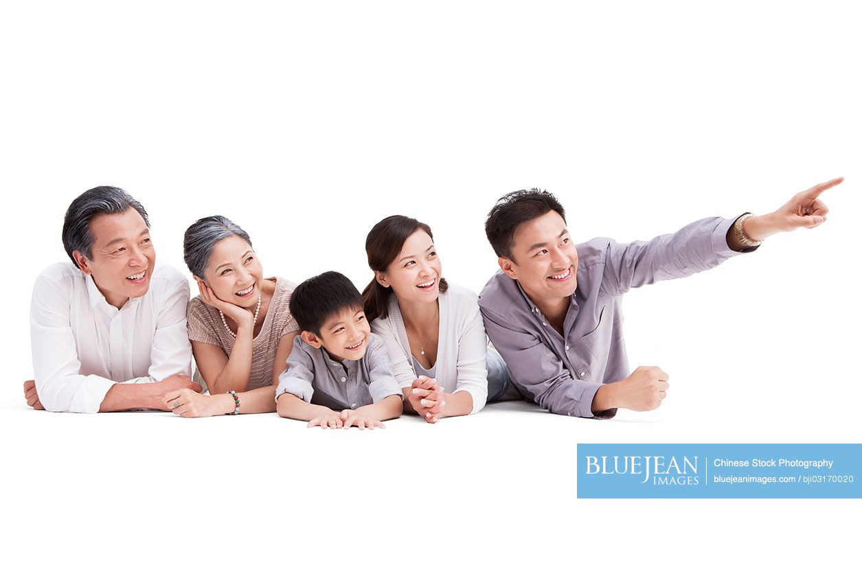 Happy Chinese family lying down on ground, looking at view-High-res ...