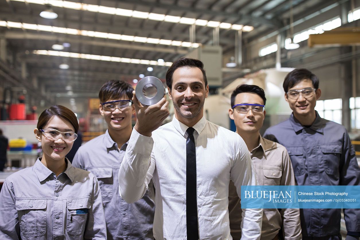 Confident businessman and engineering team in the factory-High-res ...