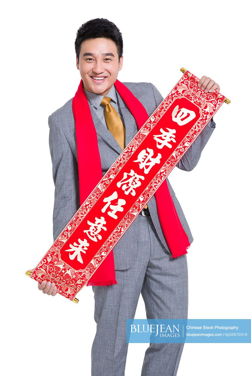 Cheerful Chinese businessman with couplet-High-res stock photo for download
