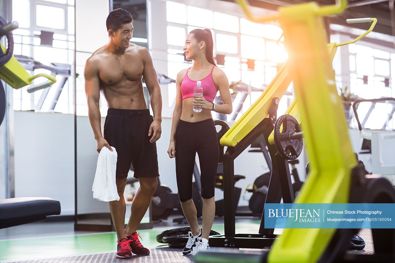 Young Chinese couple resting at gym-High-res stock photo for download