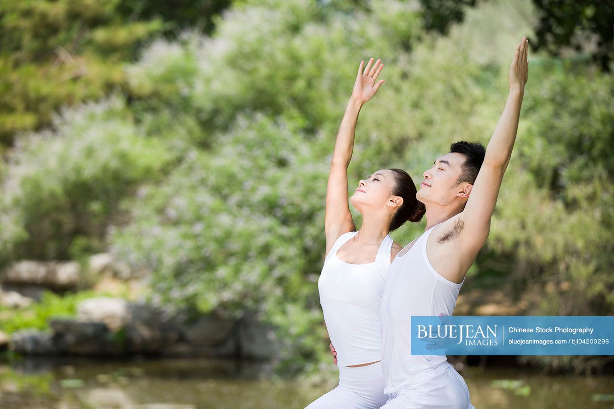 Young Chinese couple doing yoga-High-res stock photo for download