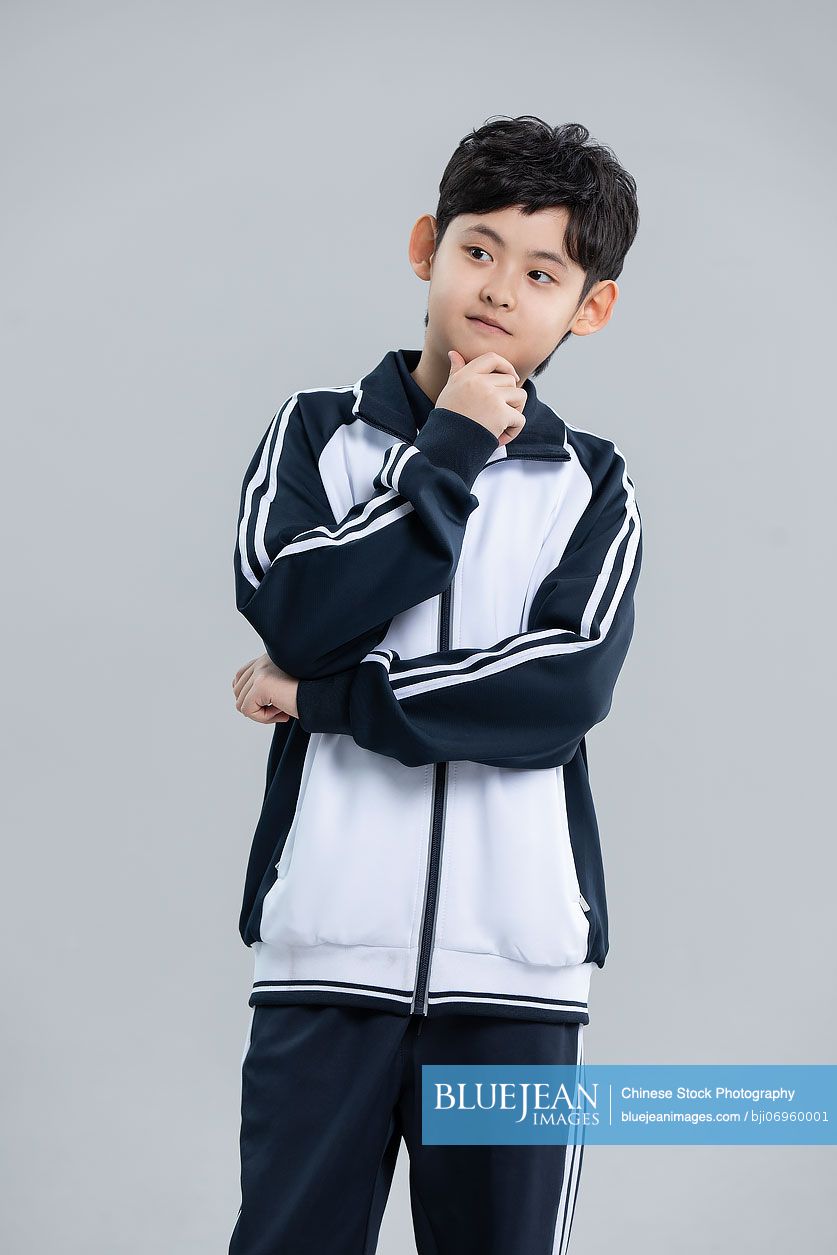 Studio shot of Chinese schoolboy thinking-High-res stock photo for download