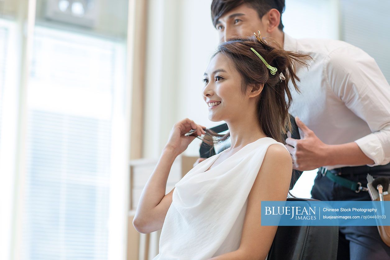 Young Chinese woman having hair done in salon-High-res stock photo for ...