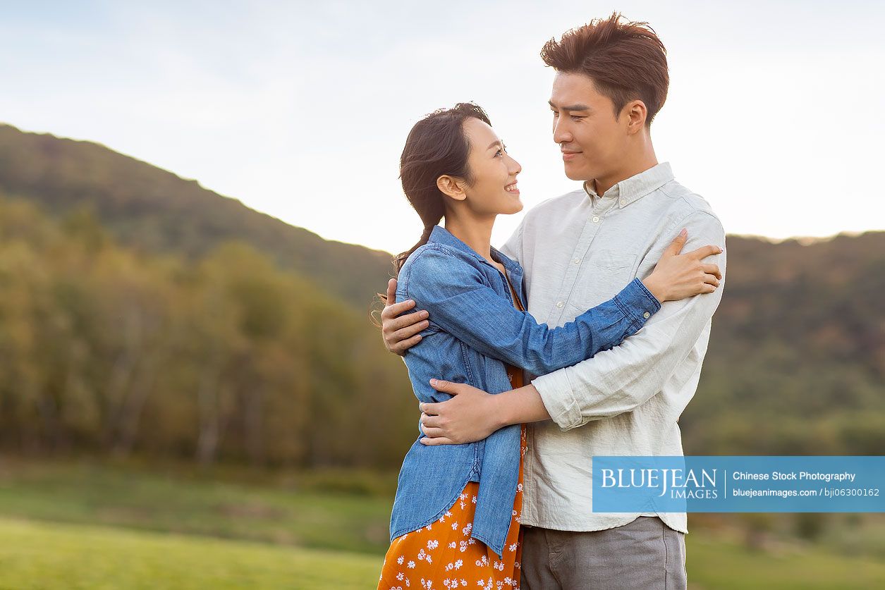 Happy young Chinese couple relaxing outdoors-High-res stock photo for download
