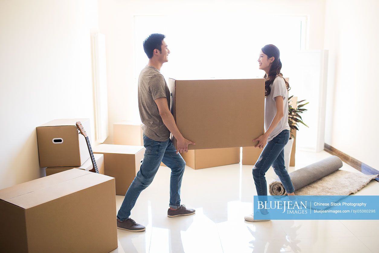 Happy young Chinese couple moving to a new house-High-res stock photo ...