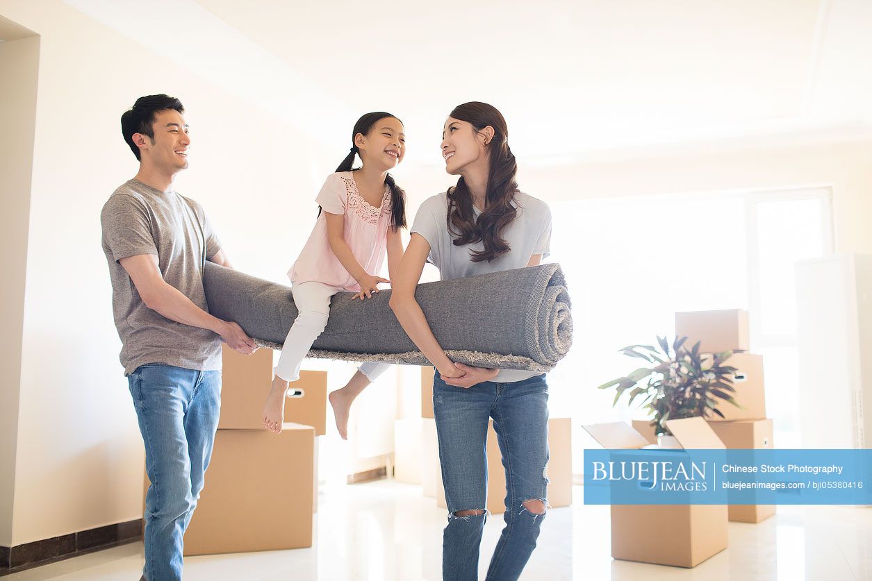 Happy young Chinese family moving to a new house-High-res stock photo ...