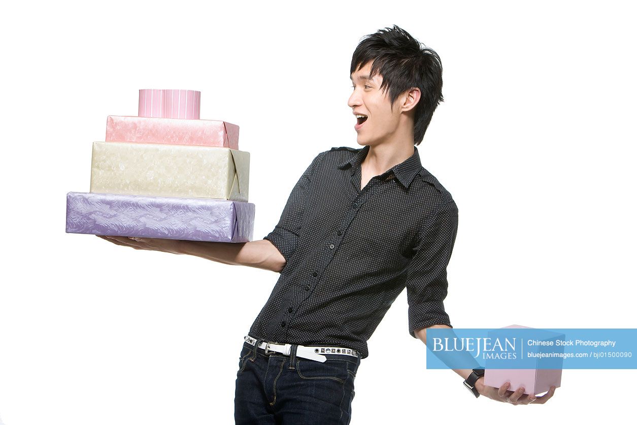 Young Chinese man with gift boxes-High-res stock photo for download