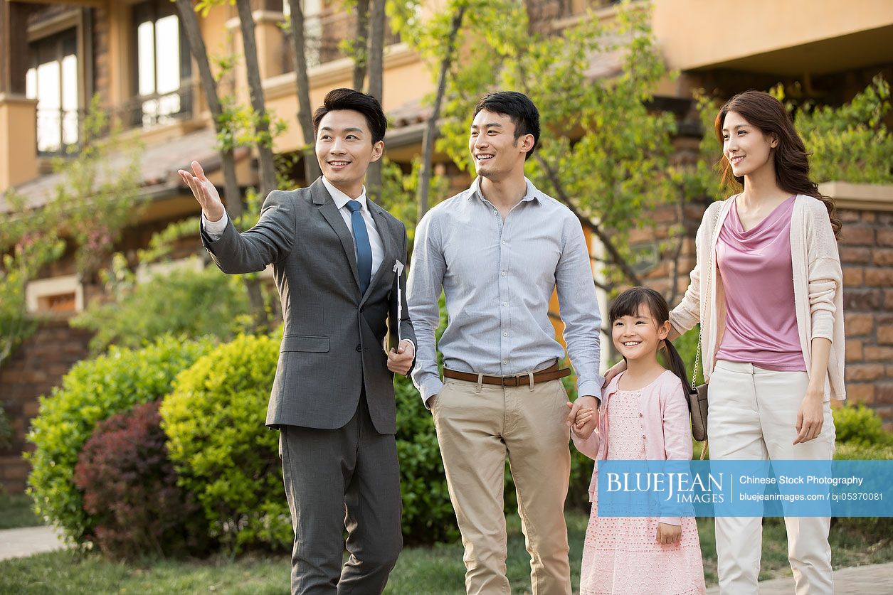 Happy young Chinese family talking with realtor-High-res stock photo ...