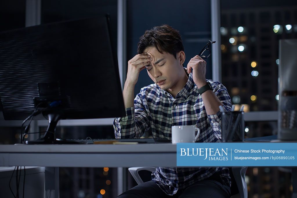 Chinese IT worker working in office at night-High-res stock photo for ...