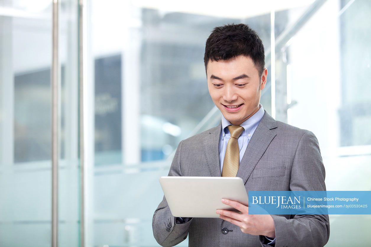 Young Chinese businessman with digital tablet-High-res stock photo for ...