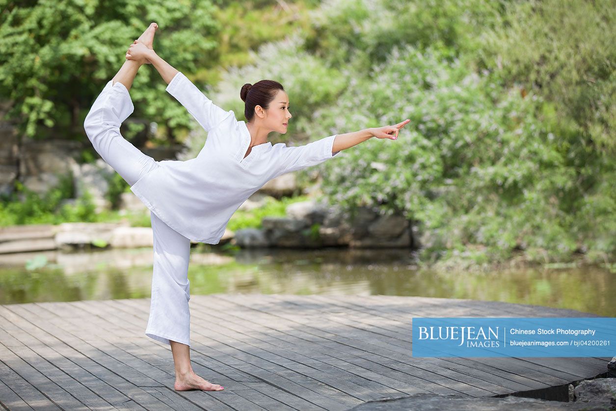 Young Chinese woman practicing yoga-High-res stock photo for download