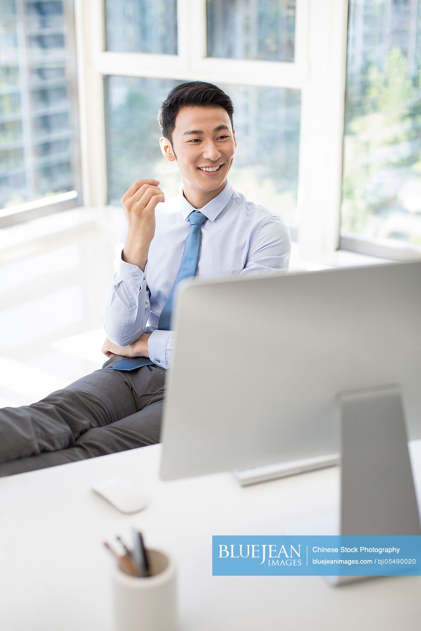 Young Chinese businessman using computer in office-High-res stock photo for download