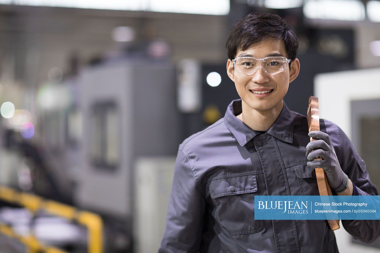 Confident Chinese engineer in the factory-High-res stock photo for download