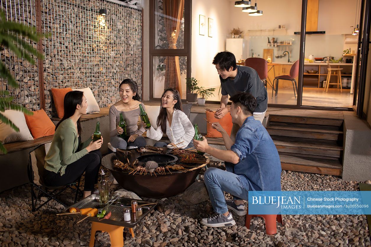 Happy young Chinese friends barbecuing outdoors-High-res stock photo ...