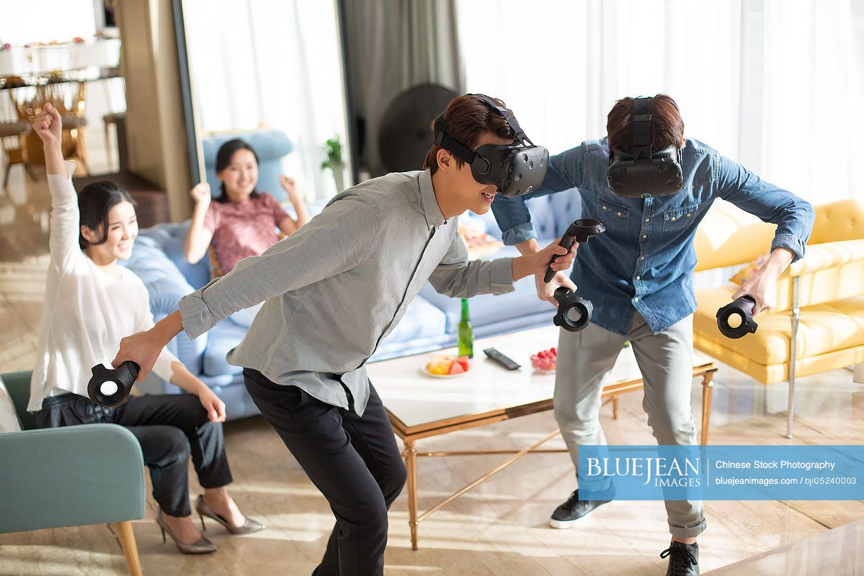 Young Chinese friends playing VR game-High-res stock photo for download