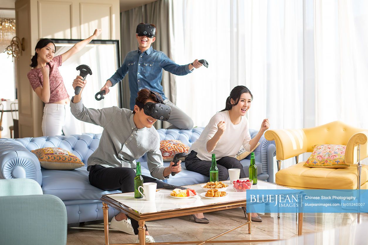 Young Chinese friends playing VR game-High-res stock photo for download