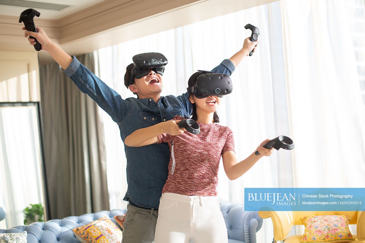 Young Chinese couple playing VR game-High-res stock photo for download