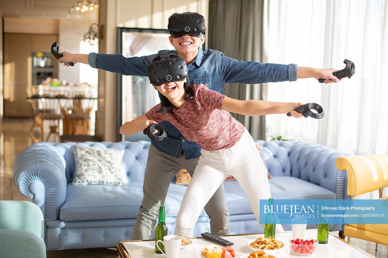 Young Chinese couple playing VR game-High-res stock photo for download