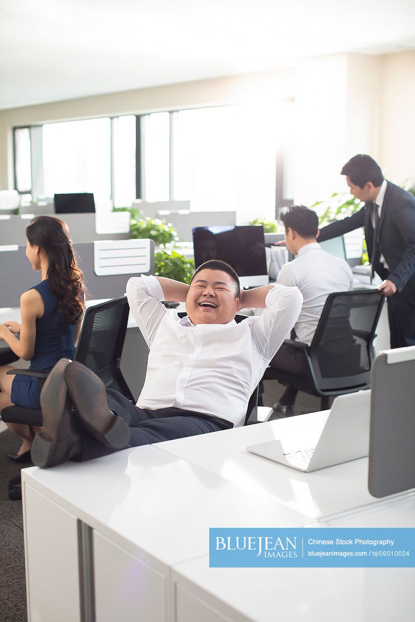 Chinese businessman slacking off in office-High-res stock photo for ...