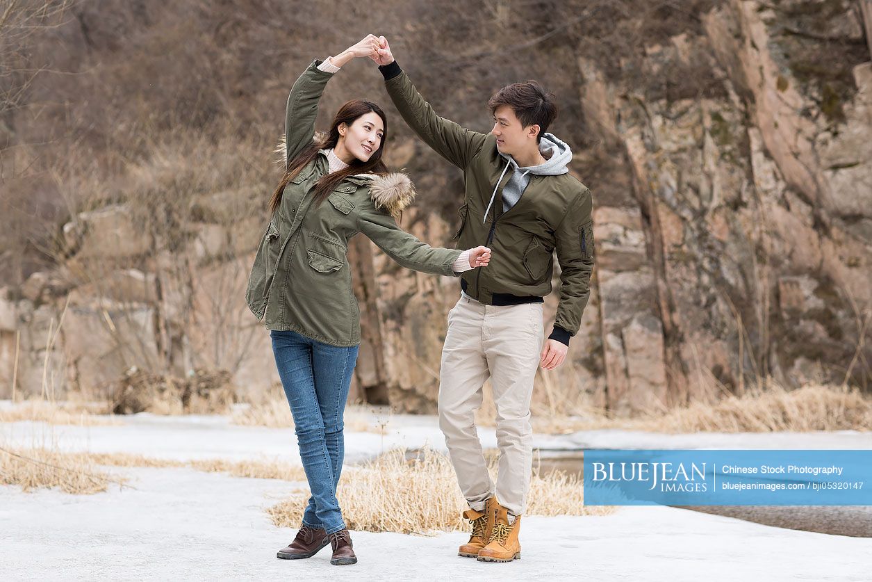 Happy young Chinese couple enjoying winter outing-High-res stock photo for download
