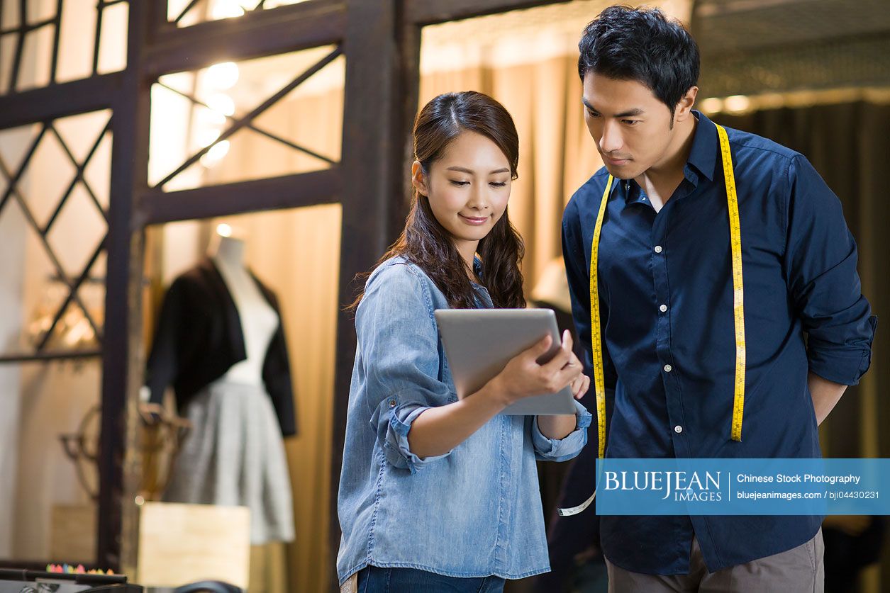 Chinese fashion designers using digital tablet-High-res stock photo for ...