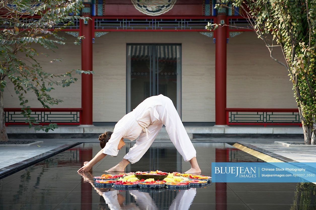 Chinese Woman Stretching In Middle Of A Pond-High-res stock photo for download