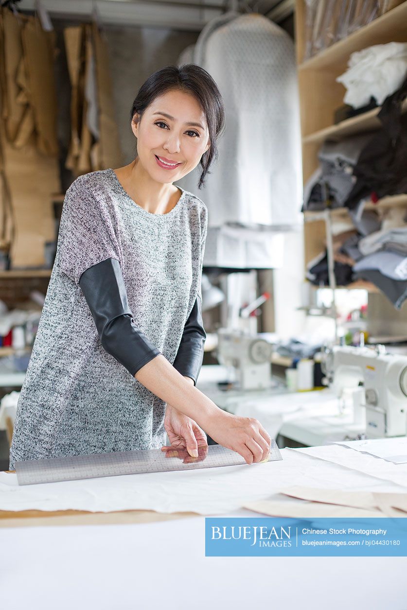 Chinese fashion designer working in studio-High-res stock photo for ...