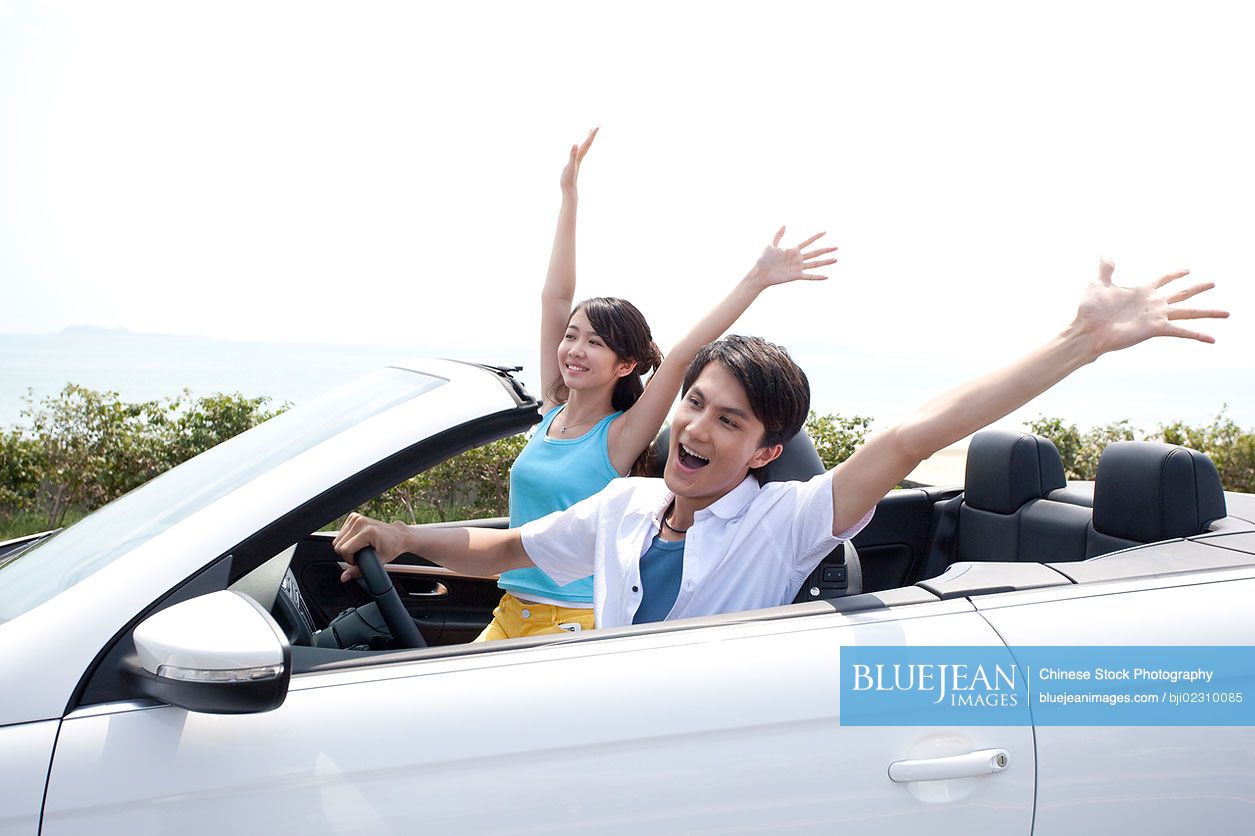 Young Chinese people having fun in a convertible-High-res stock photo ...