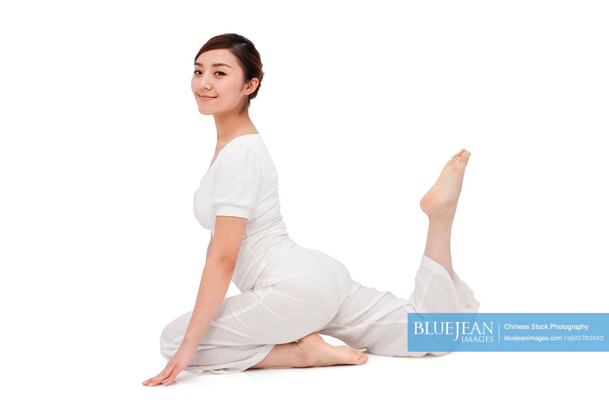 Young Chinese woman stretching on the floor-High-res stock photo for ...