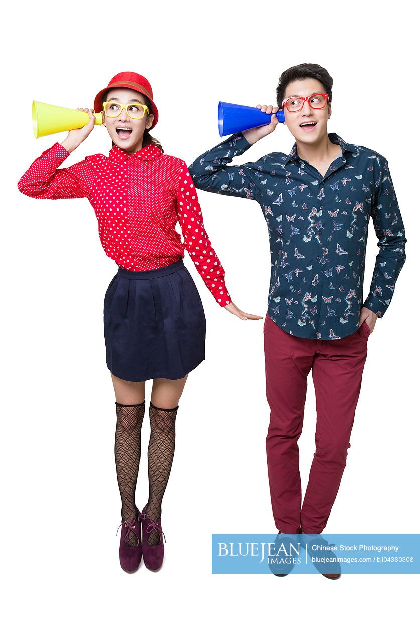 Young Chinese couple listening through megaphones-High-res stock photo for download
