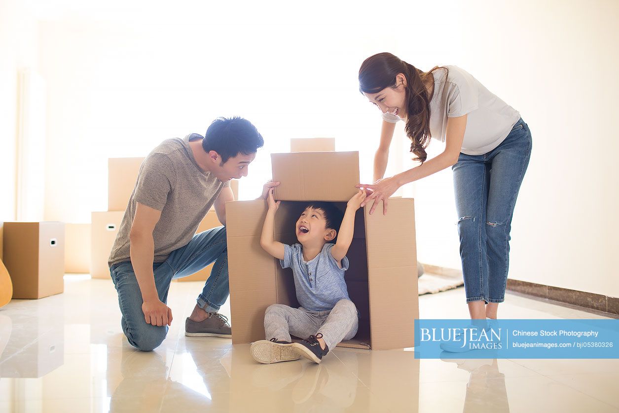 Happy young Chinese family moving to a new house-High-res stock photo ...