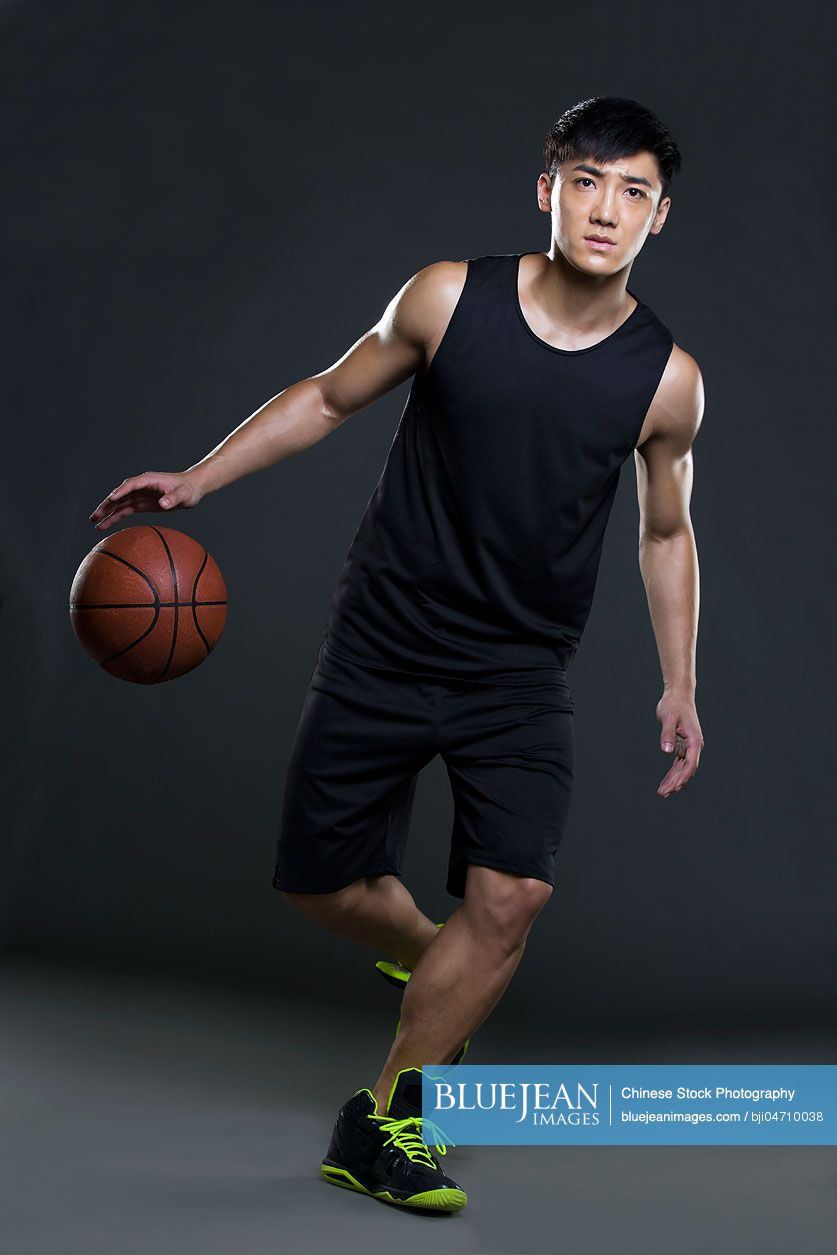 Young Chinese man playing basketball-High-res stock photo for download