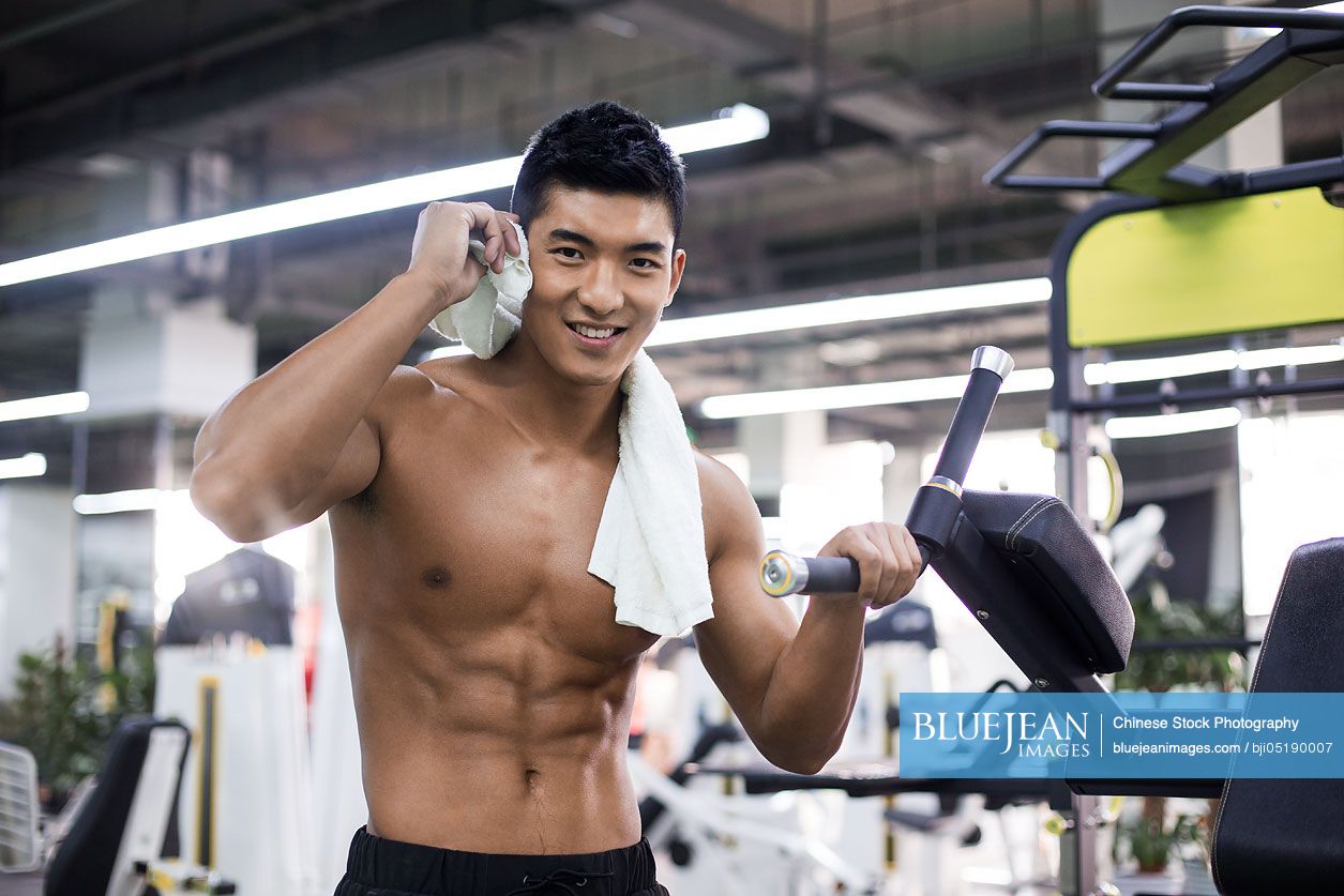 Young Chinese man resting at gym-High-res stock photo for download