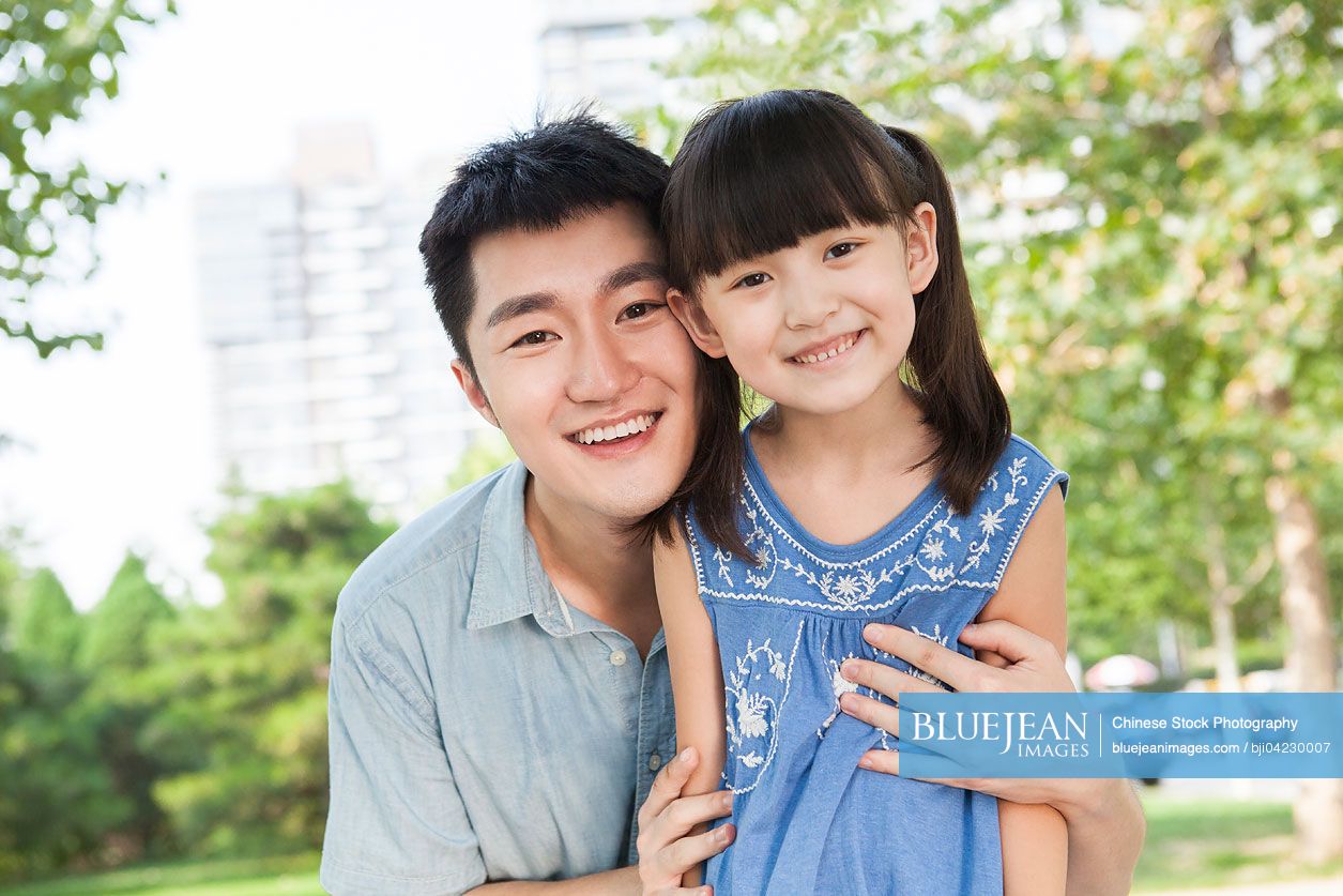 Portrait of happy young Chinese father and daughter-High-res stock ...