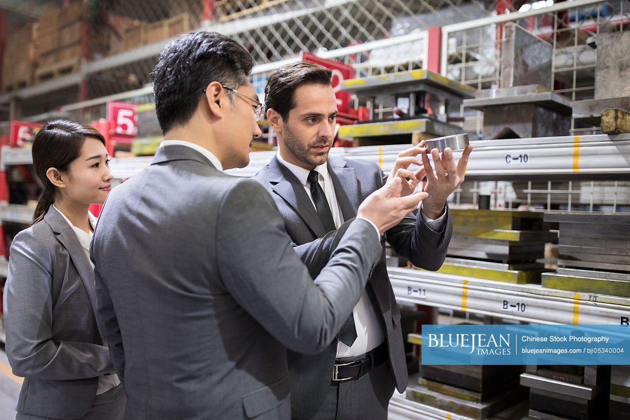 Business people checking machine parts in the factory-High-res stock ...