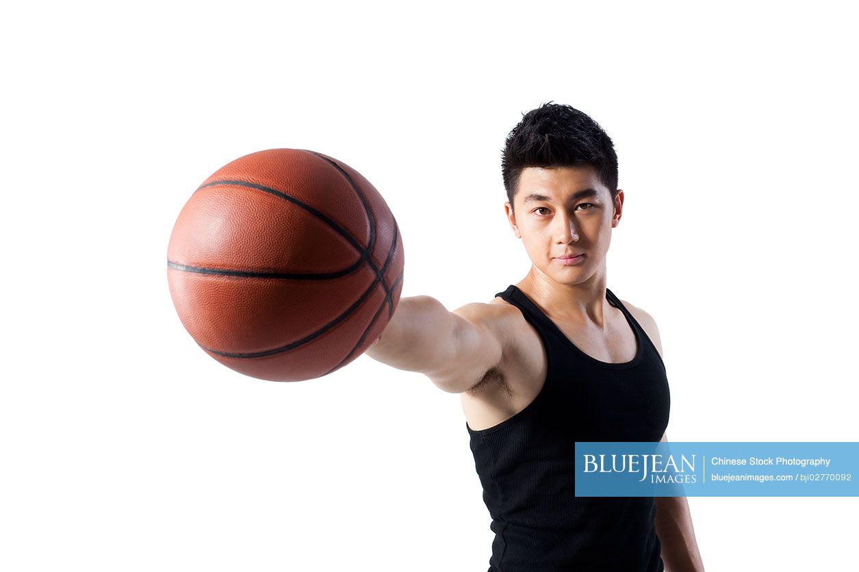 Chinese man holding a basketball with one hand-High-res stock photo for ...