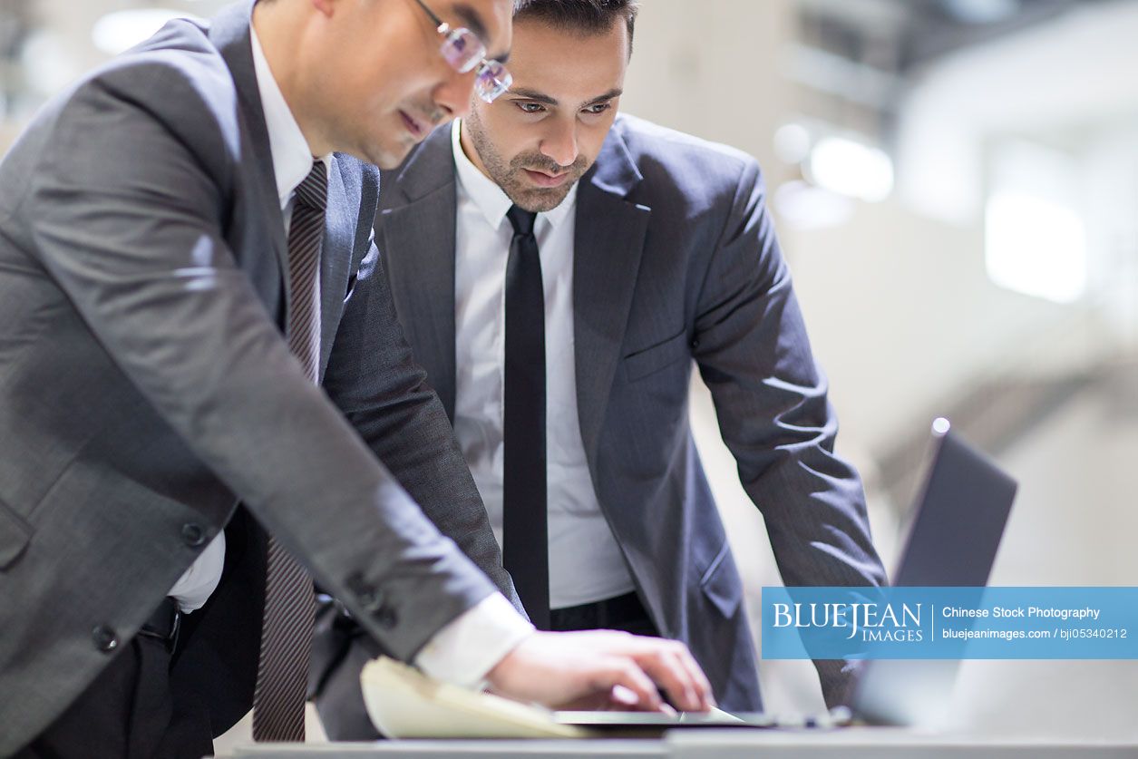 Businessmen working with laptop in the factory-High-res stock photo for ...