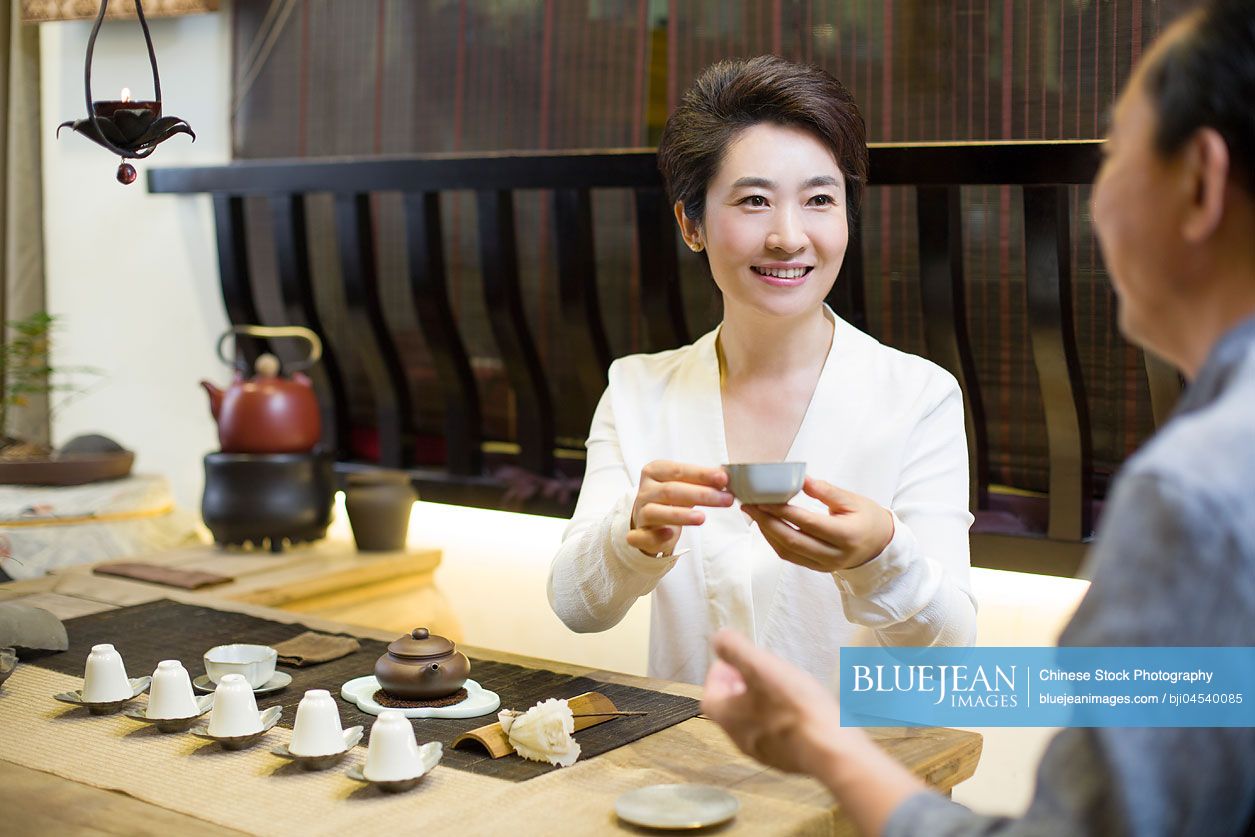 Chinese friends drinking tea and talking in tea room-High-res stock ...