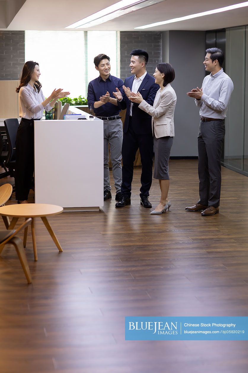 Chinese Business People Applauding In The Office High res Stock Photo chinese-business-people-applauding-in-the-office-high-res-stock-photo