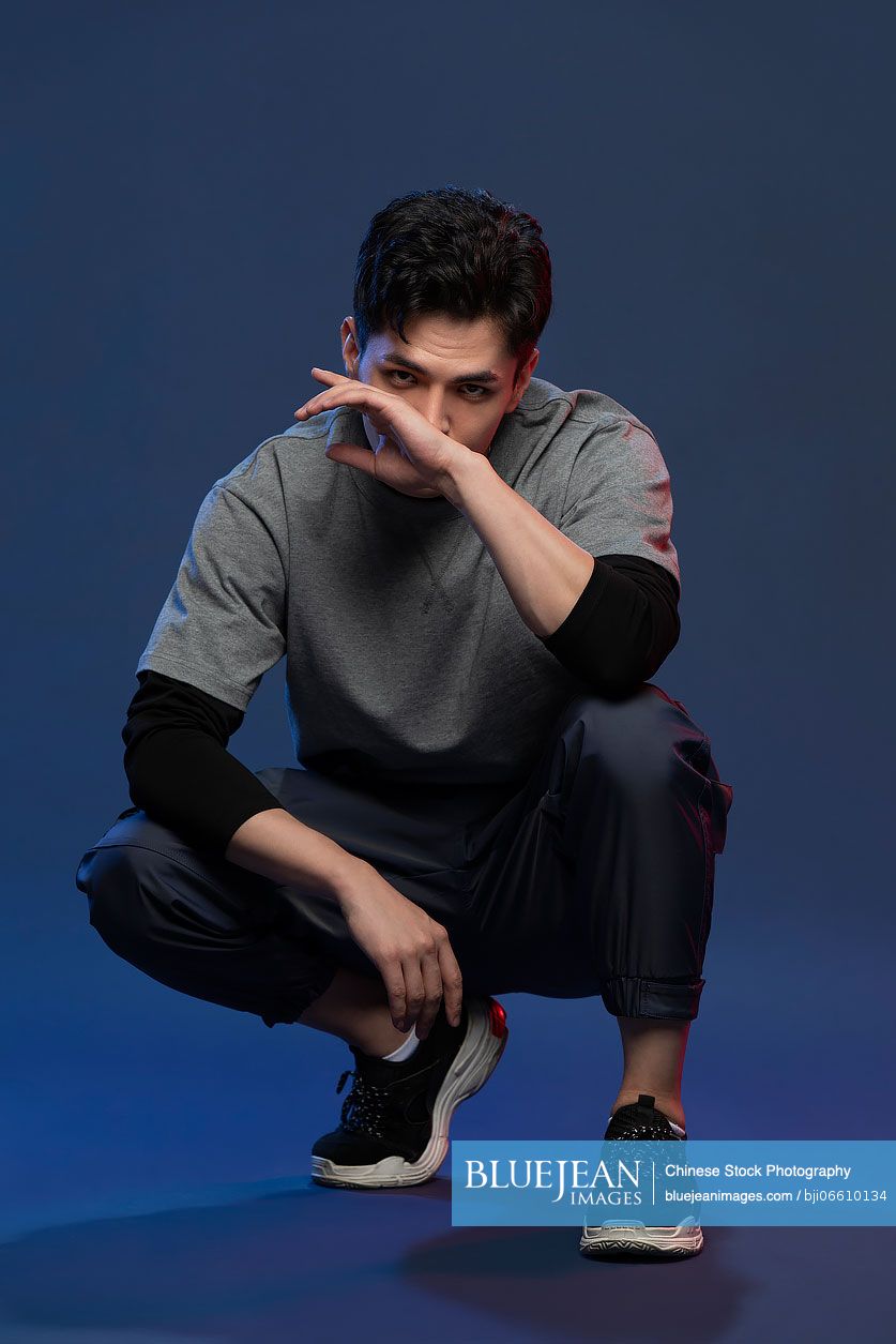 Studio shot of fashionable young Chinese man dancing-High-res stock ...